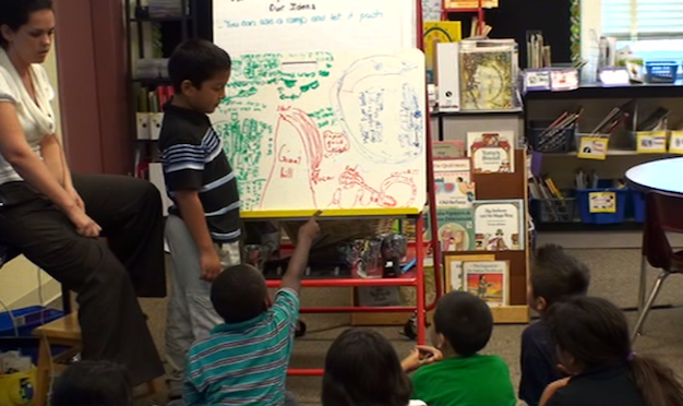 Student presenting ideas about making cars move to Sharon's class